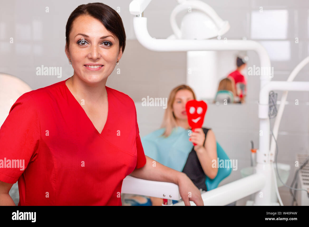 Dentist doctor poses for the camera on the background of the dental ...