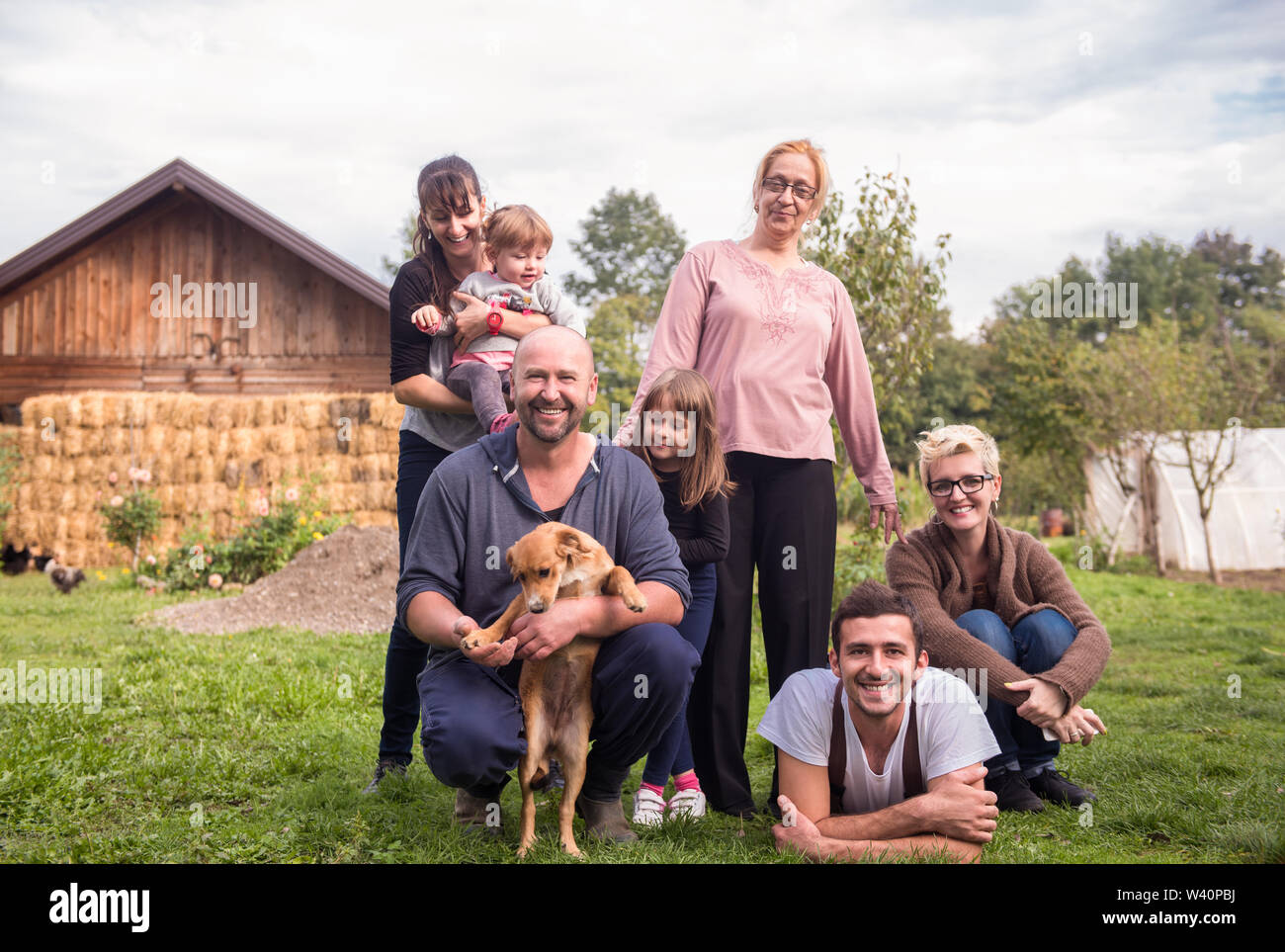 portrait of happy three generations family with dog at beautiful ...