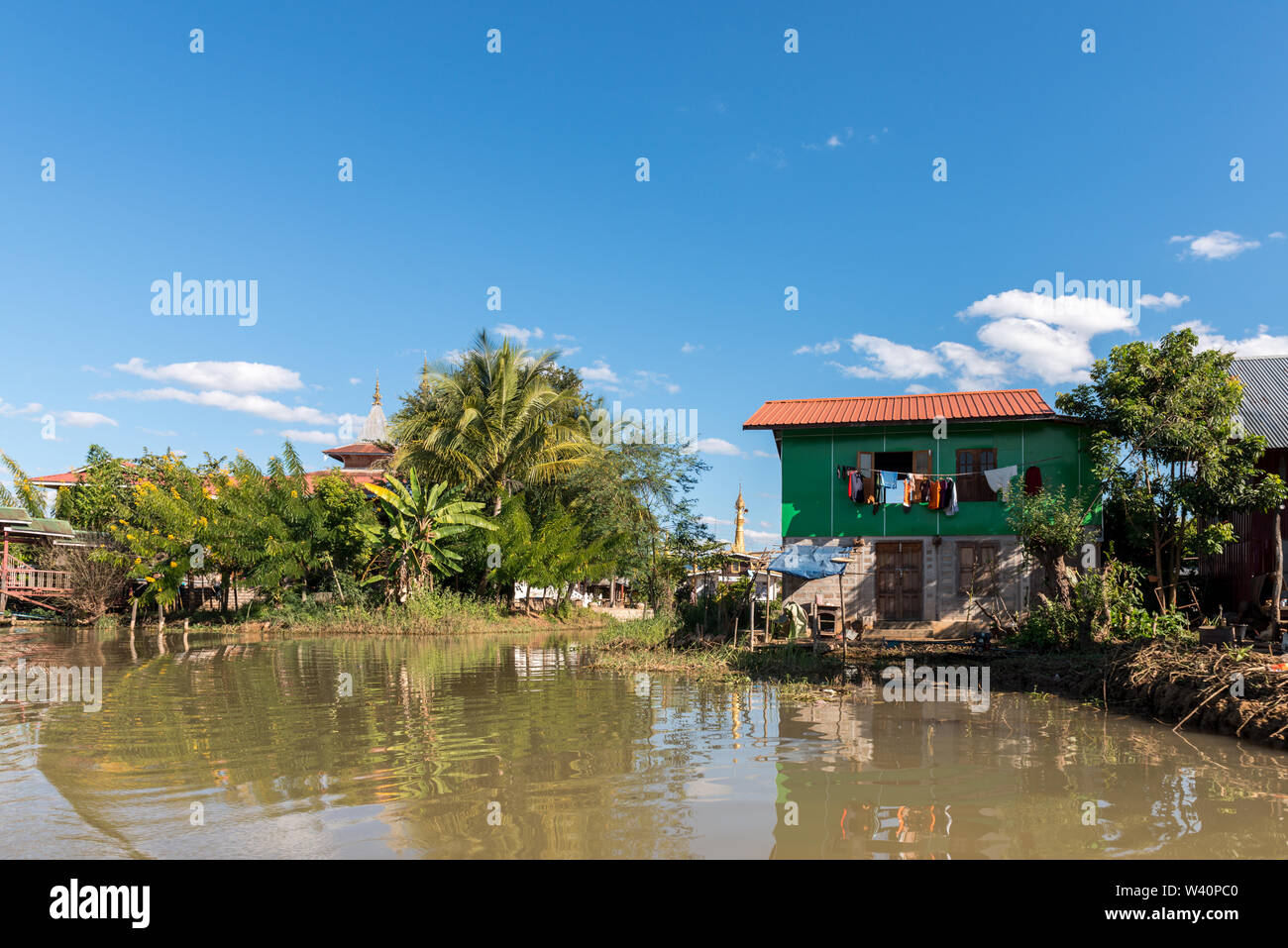 Wide angle picture from the boat of small poor houses with beautiful ...