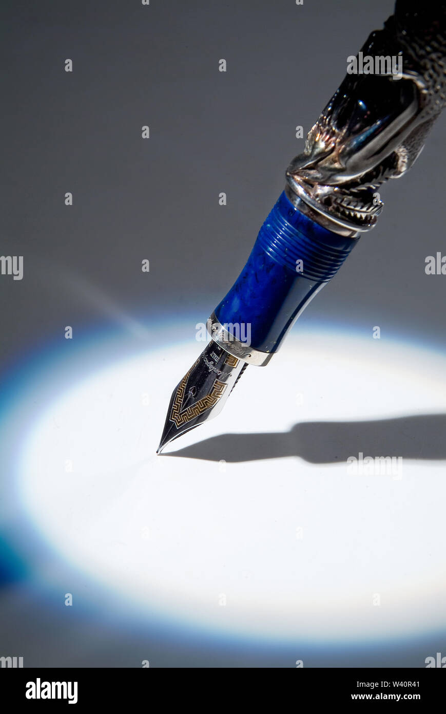 Pen and shadow on a studio background Stock Photo - Alamy