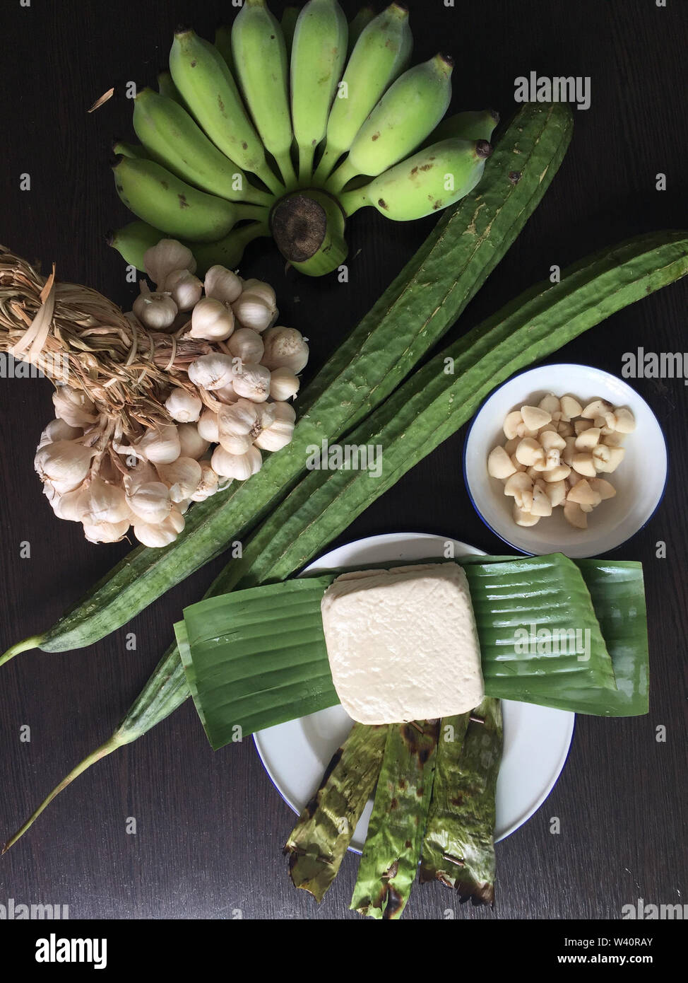 Asian cuisine ingredients over black background, top view, copy space ...