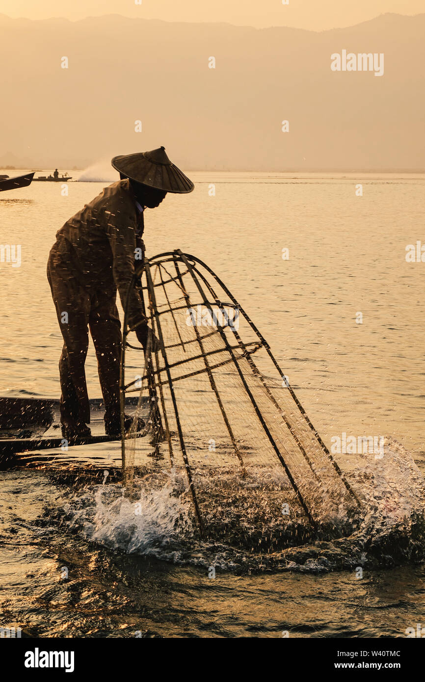 Inle Lake, Myanmar - Feb 16, 2016. Intha man using the unique methods ...