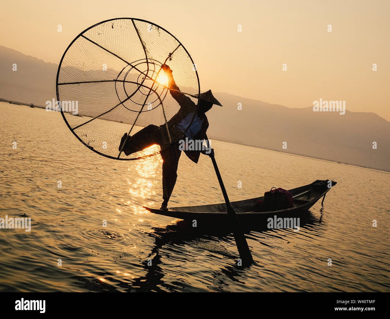 Inle Lake, Myanmar - Feb 16, 2016. Intha man using the unique methods ...