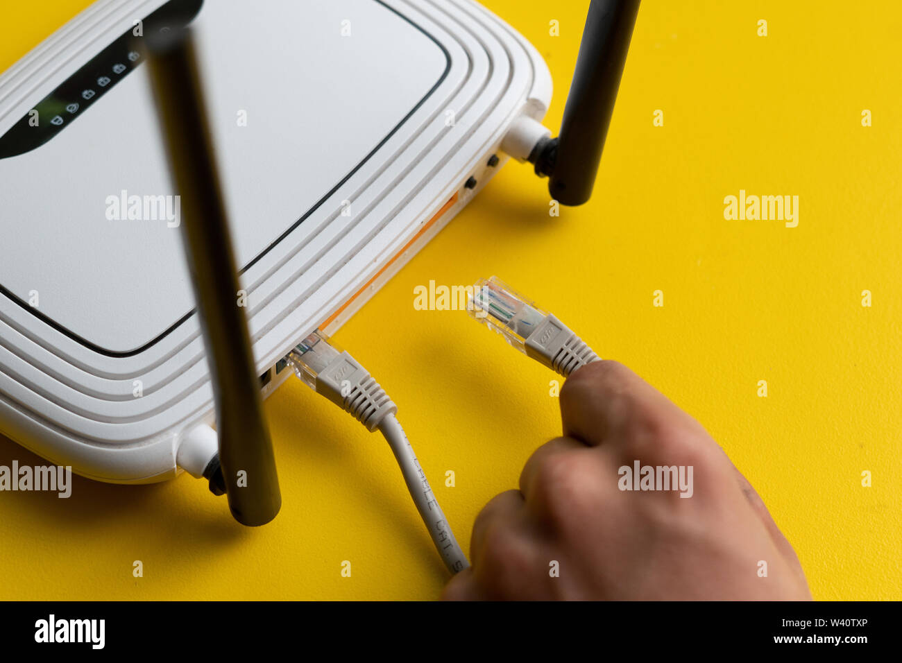 hand conncecting the ethernet wire cable with wi-fi remote point Stock ...