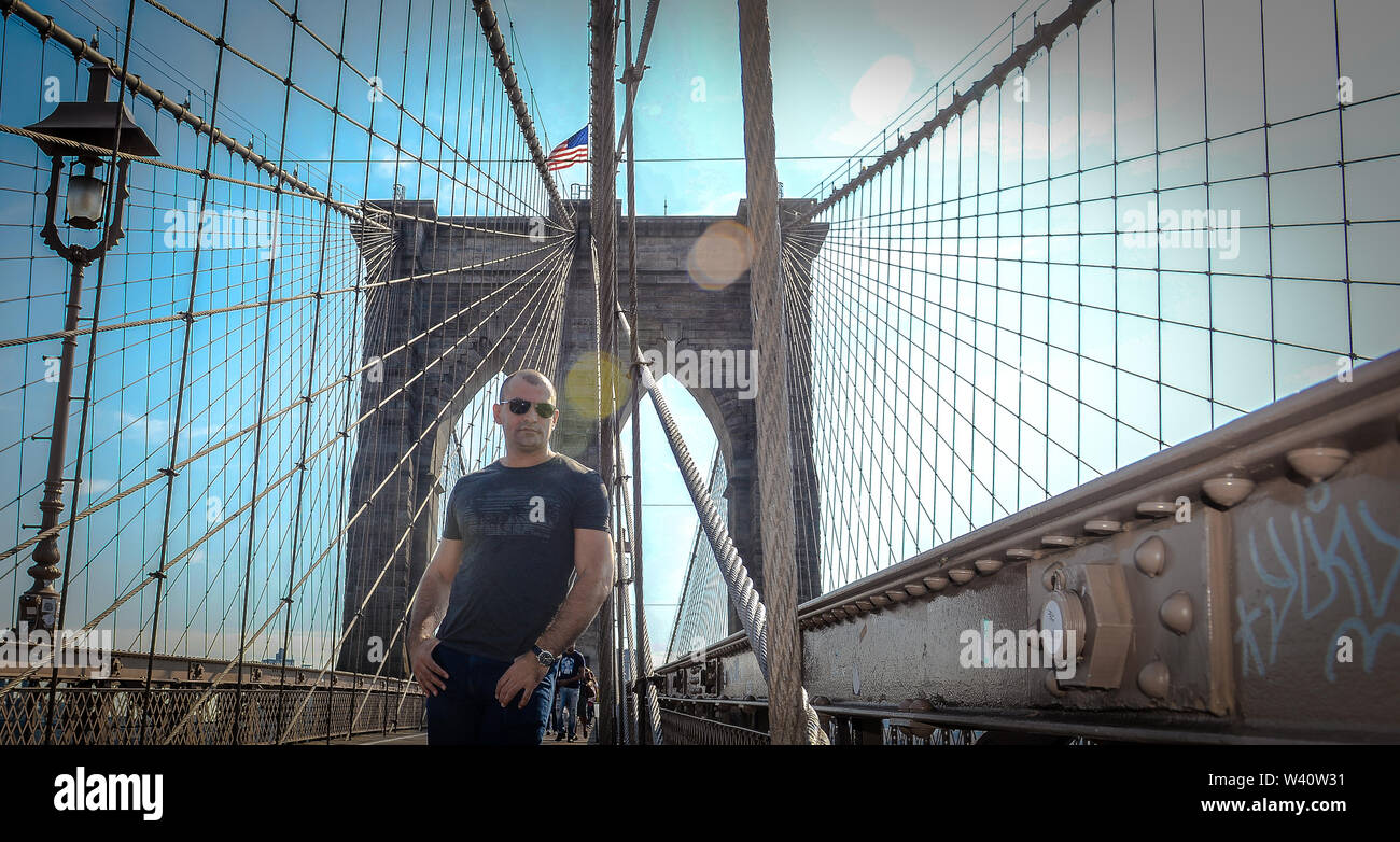 Young Man Posing on the Brooklyn Bridge on sunny day Stock Photo - Alamy