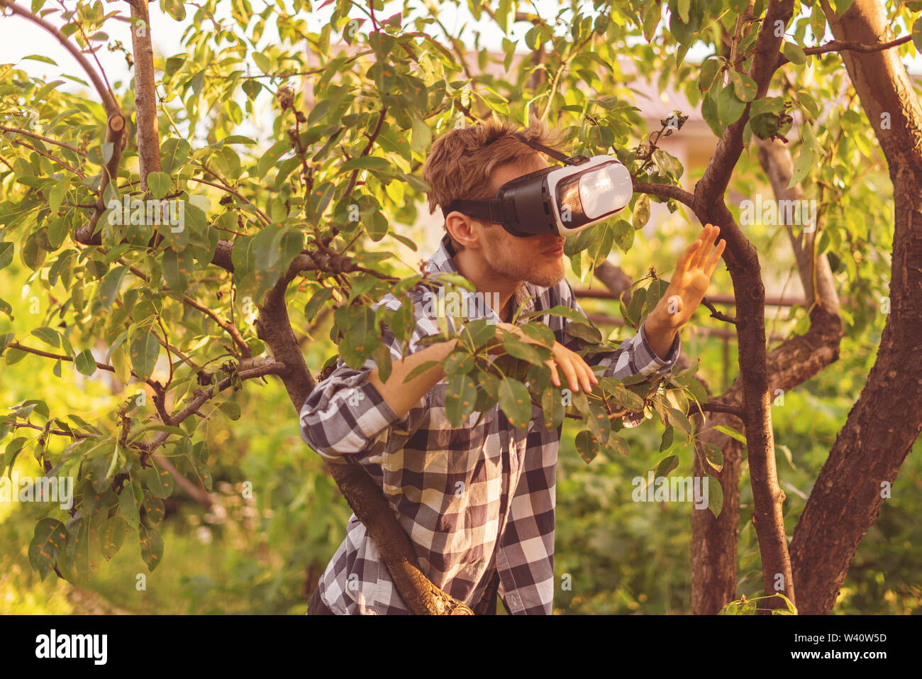 farmer using his cr glasses to plant some trees, future agriculture ...