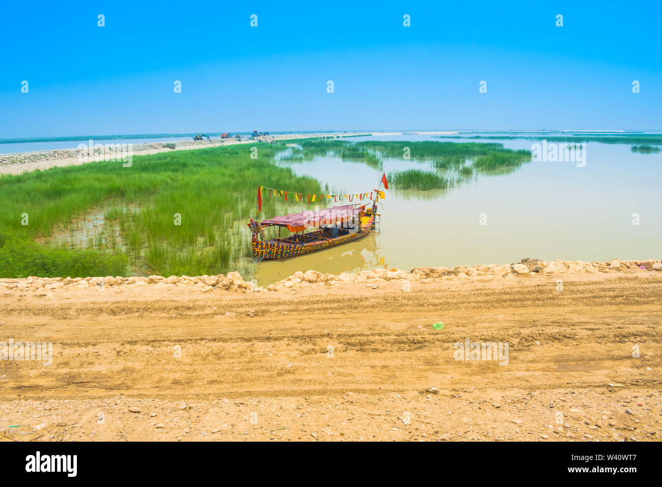 a long boat in river indus pakistan,a boat between water plants at ...