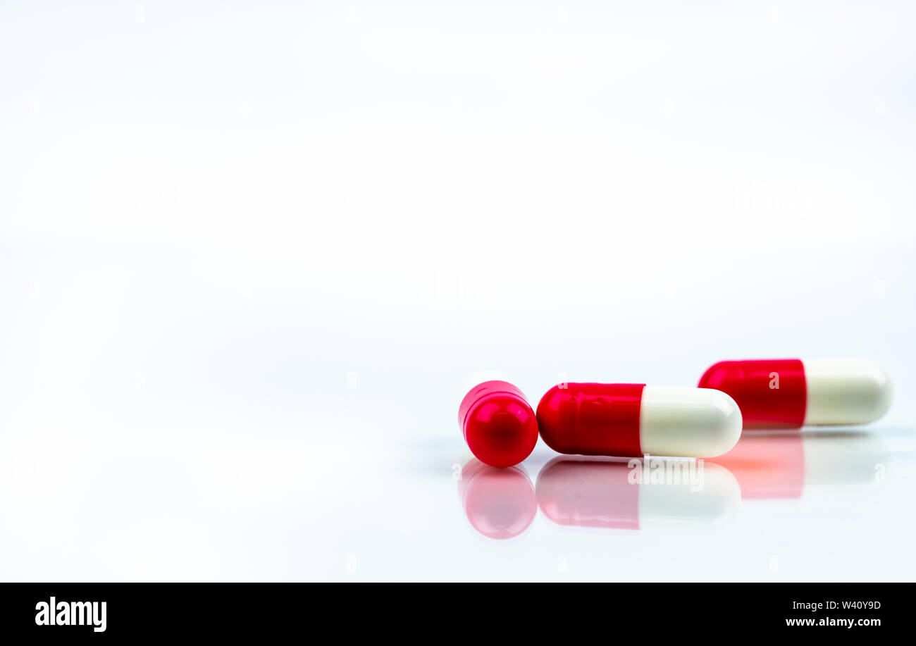 Red-white capsule pill isolated on white background. Antibiotic drug ...
