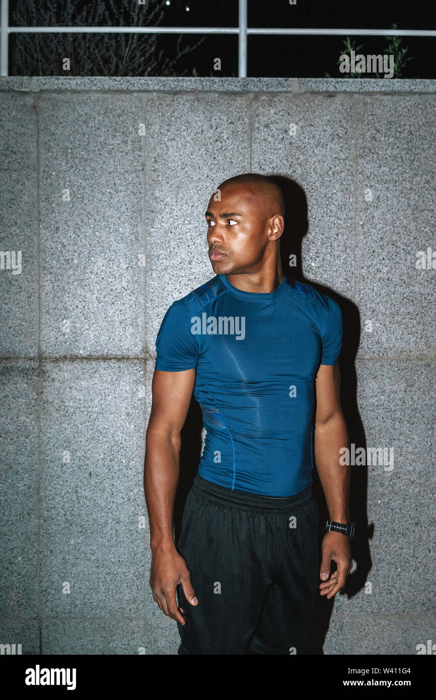 Image of a handsome strong african sports man at night outoors posing ...