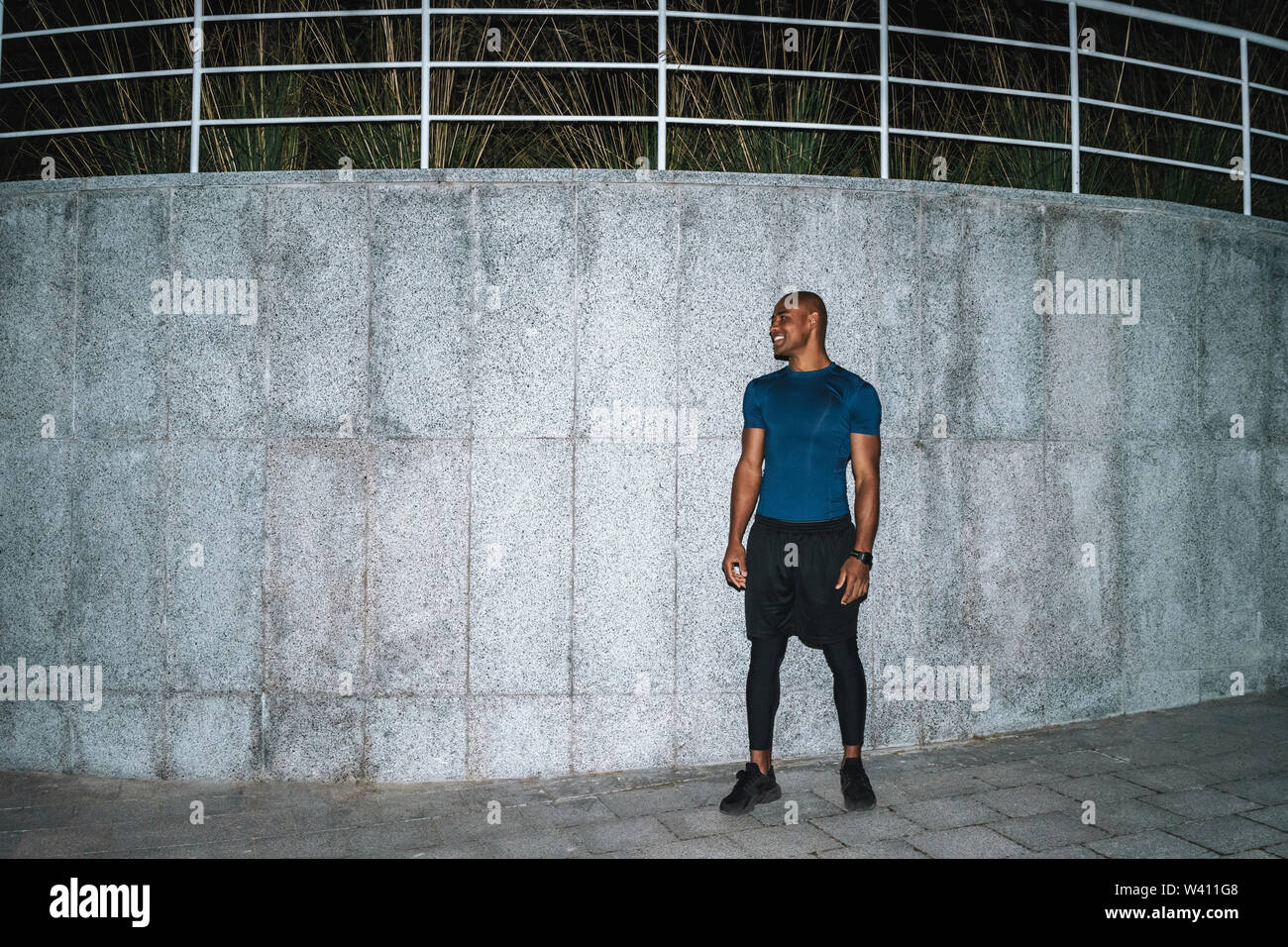Image of a handsome strong african sports man at night outoors posing ...