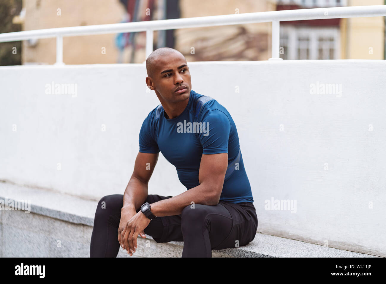 Handsome fit african fitness man resting after workout outdoors ...