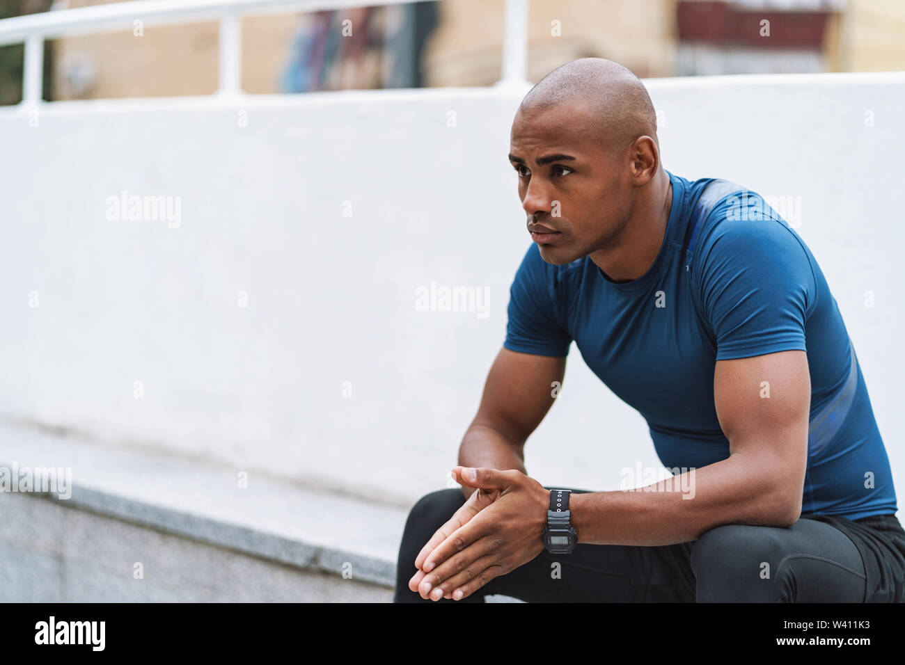 Handsome fit african fitness man resting after workout outdoors ...