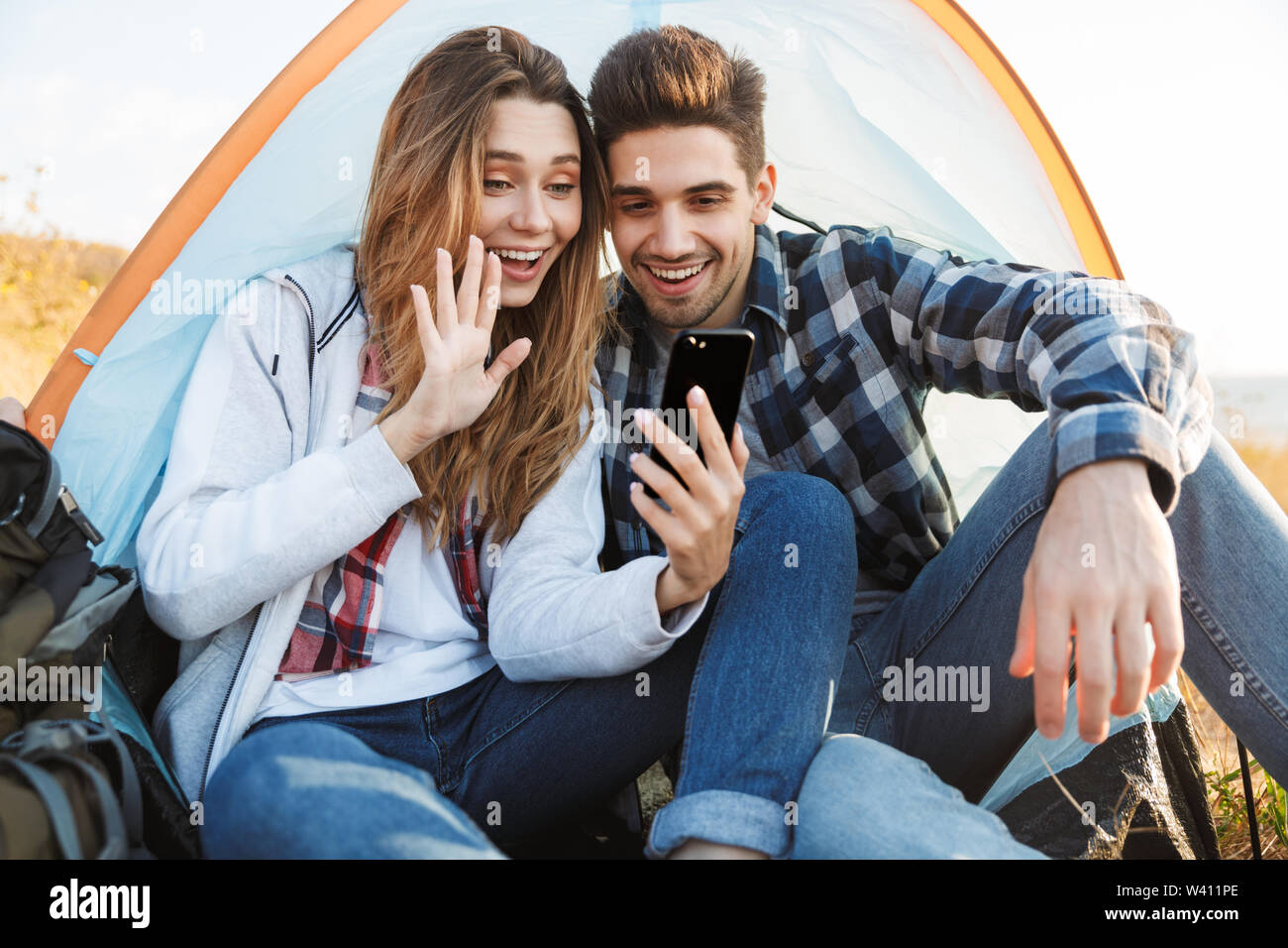 Photo of happy young loving couple outside in free alternative vacation ...