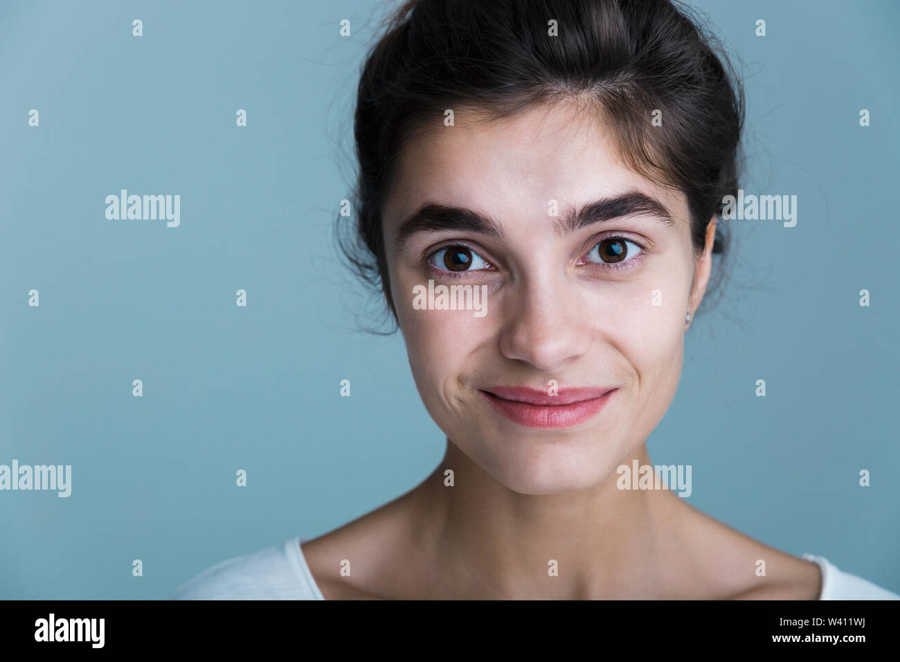 Close Up Portrait Of A Pretty Smiling Young Brunette Woman Wearing