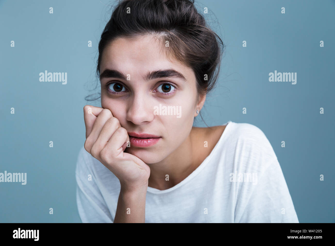 Close Up Portrait Of A Pretty Young Brunette Woman Wearing White T