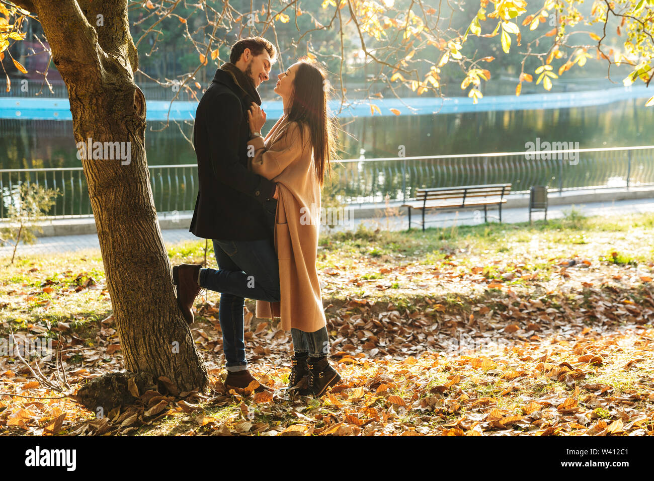 Image of a happy young beautiful loving couple posing walking outdoors ...