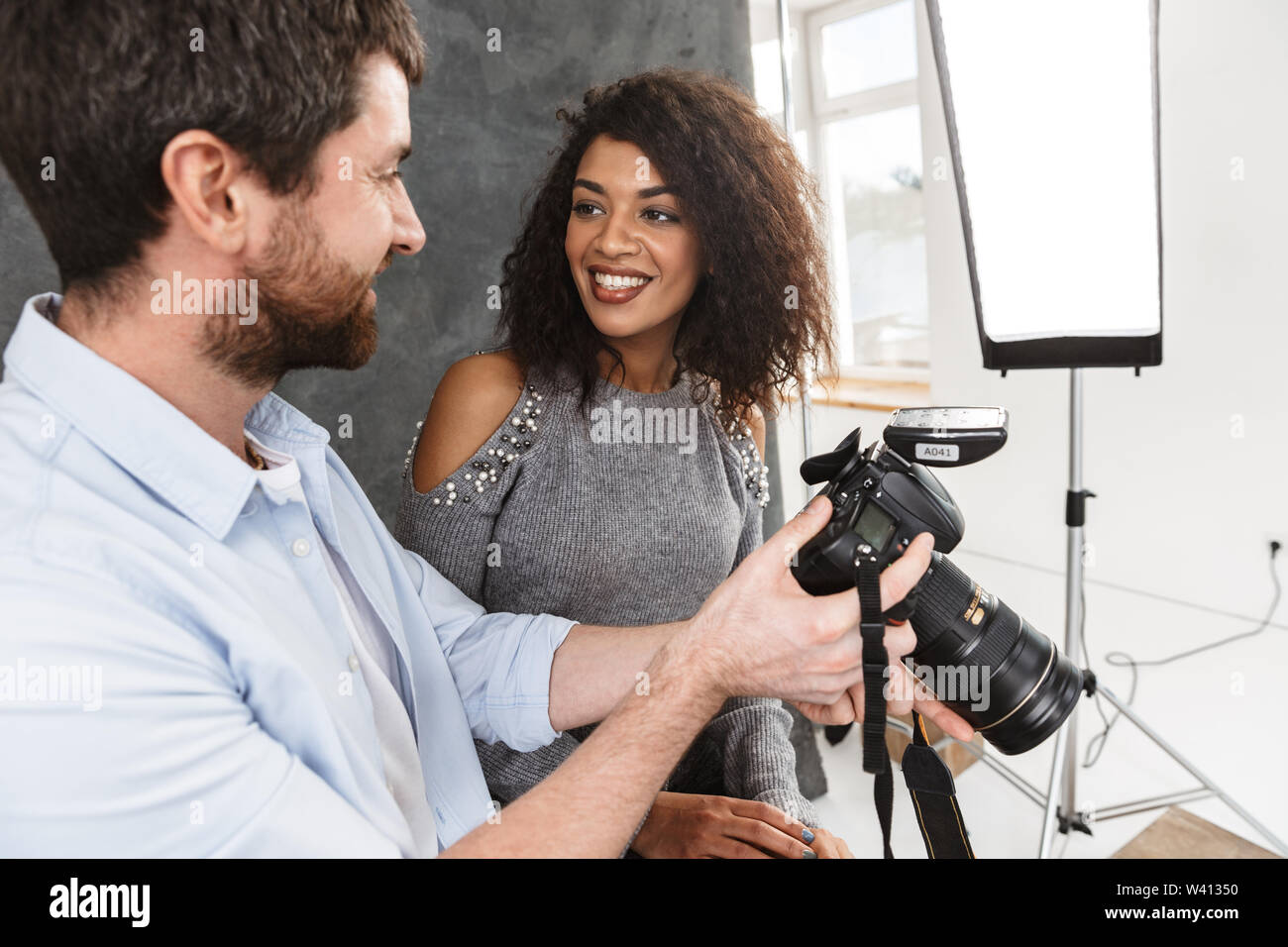 Portrait of handsome photographer man shooting lovely african american ...