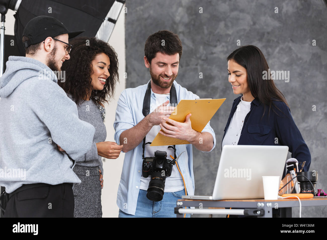 Portrait of smiling multiethnic people men and women talking while ...