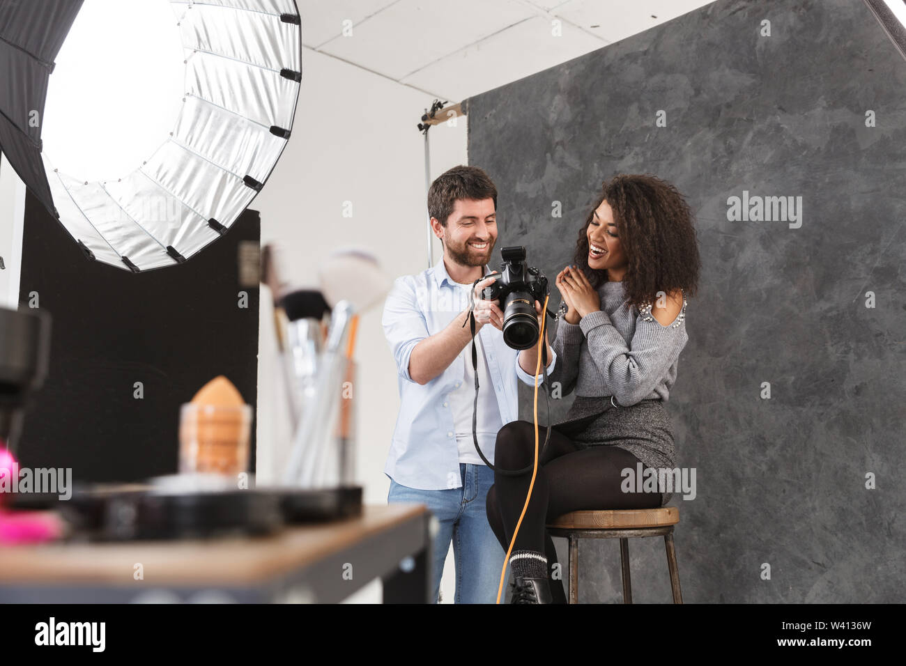 Portrait of handsome photographer man shooting cheerful african ...