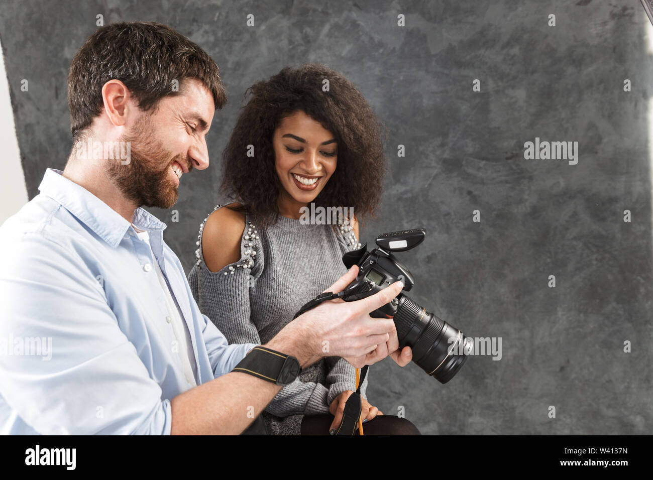 Portrait of handsome photographer man shooting charming african ...