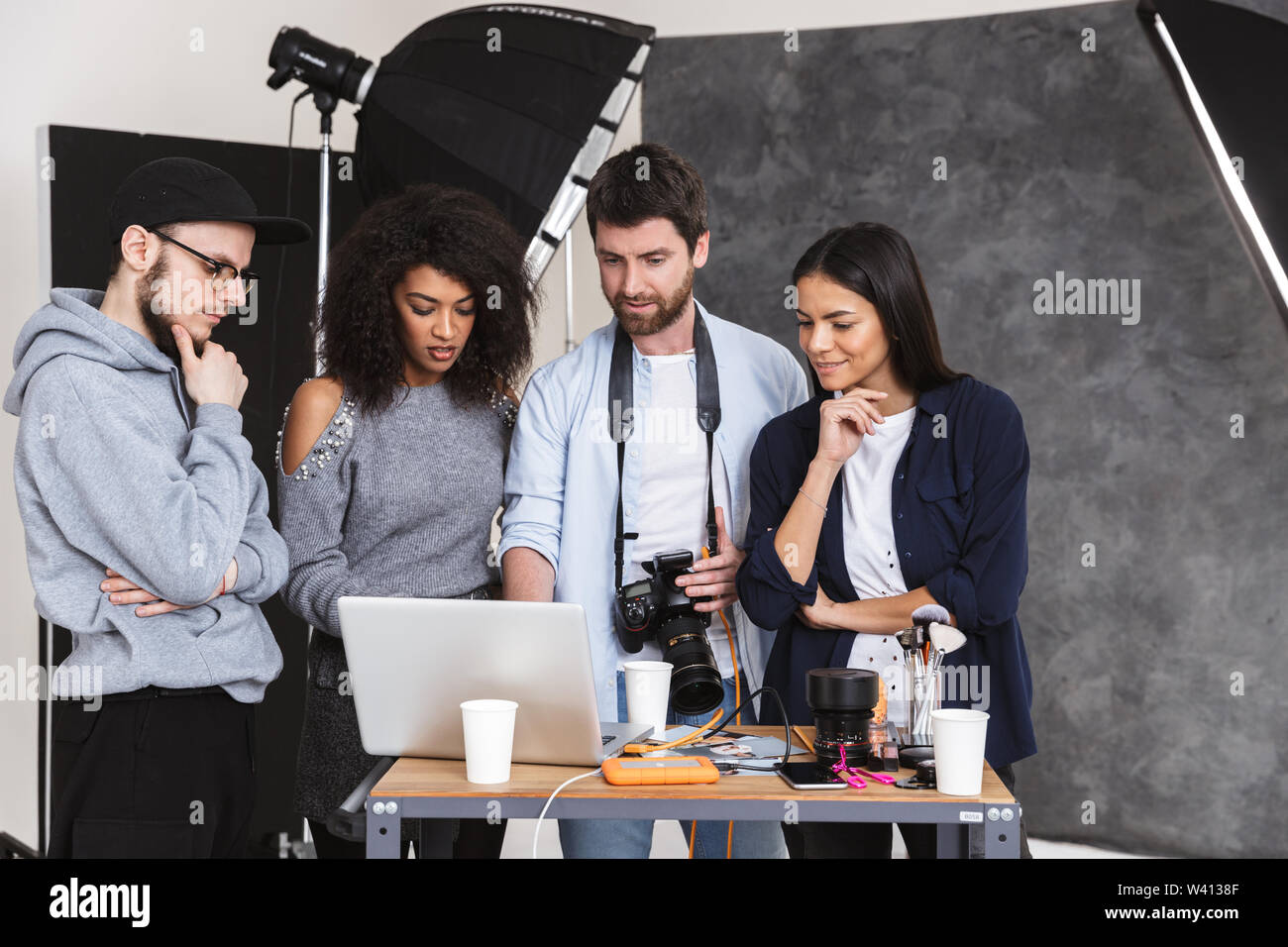 Portrait of positive multiethnic people men and women talking while ...