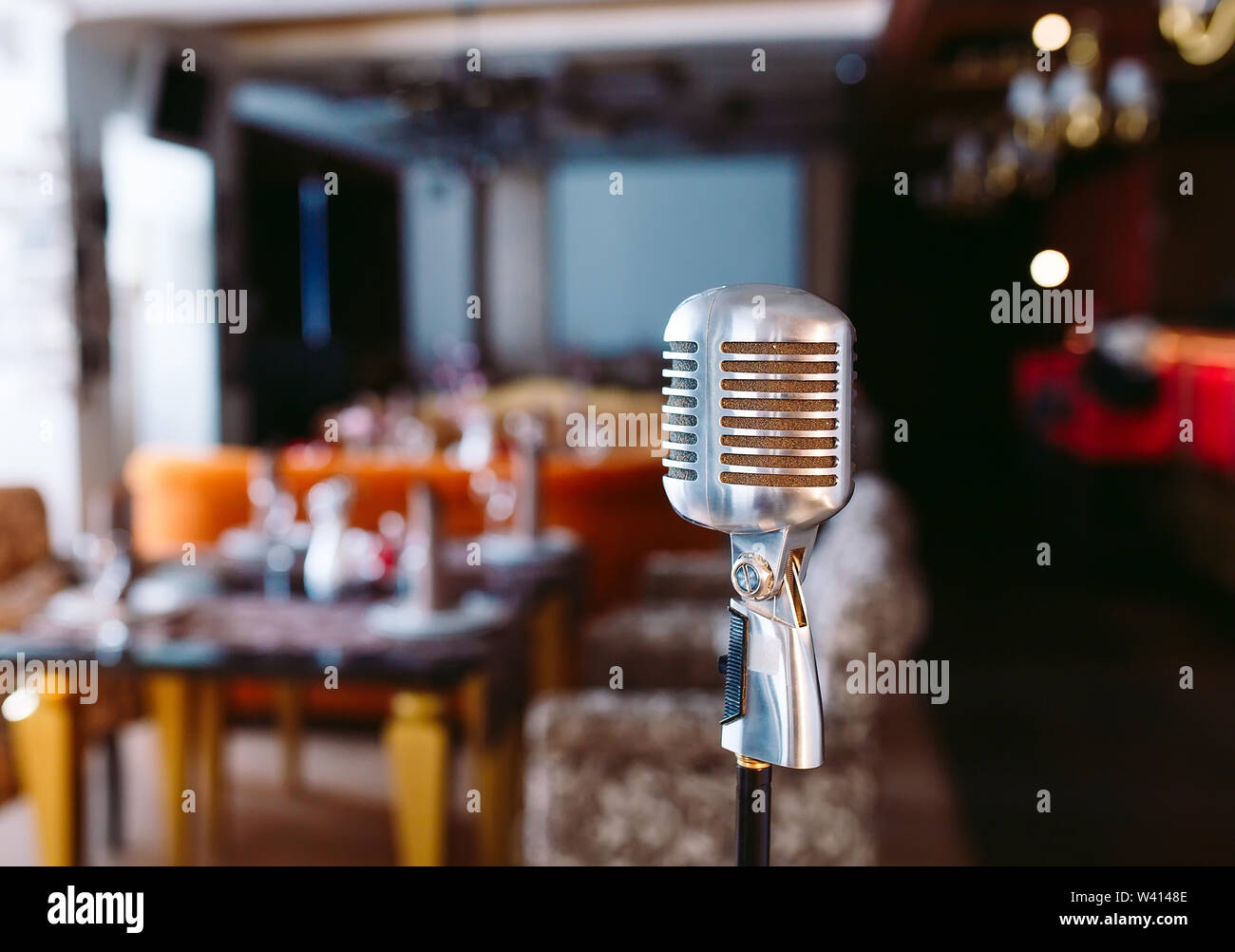 Retro karaoke microphone on a restaurant background Stock Photo - Alamy