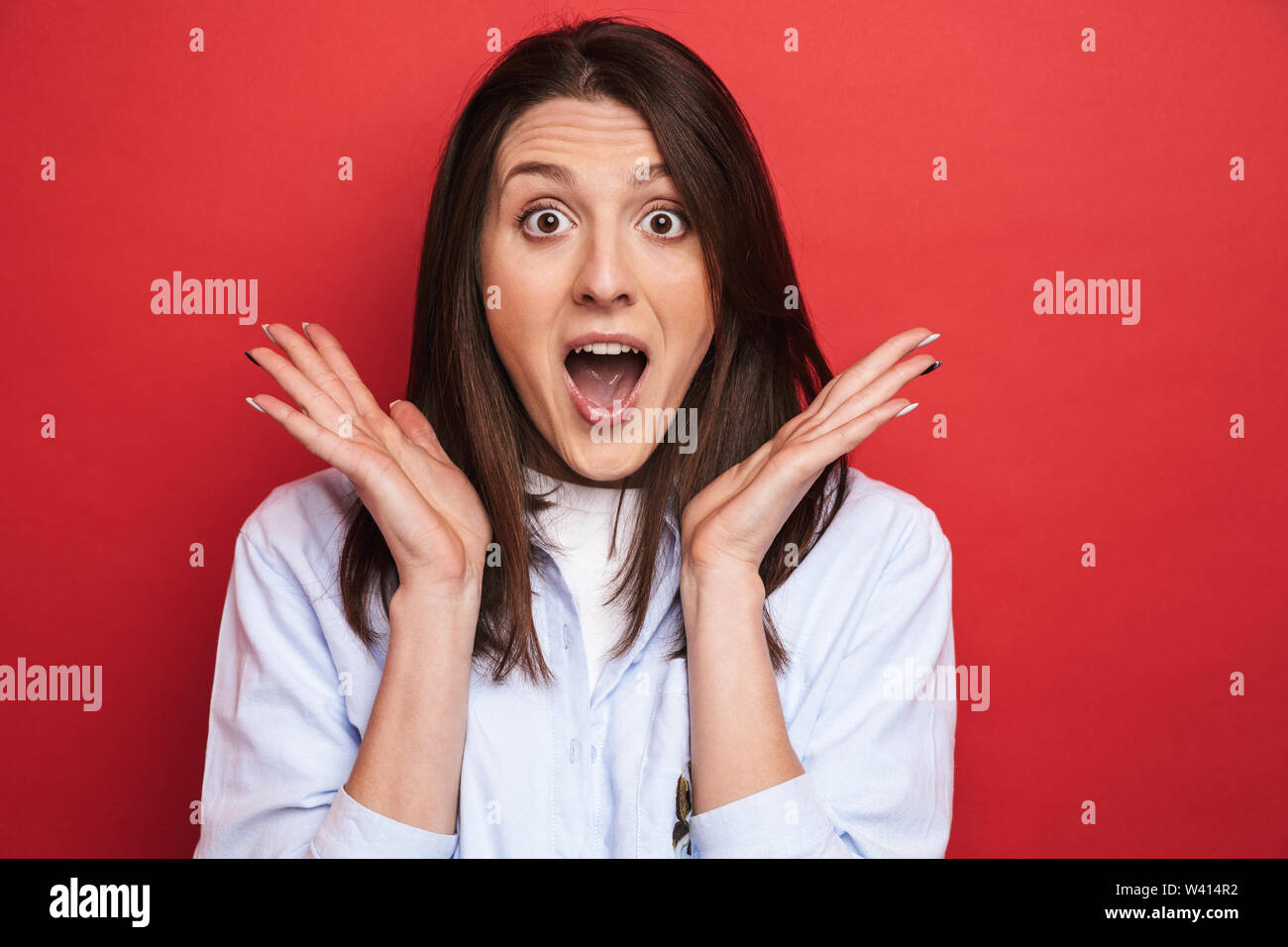 Photo of an amazing shocked emotional young beautiful woman posing ...