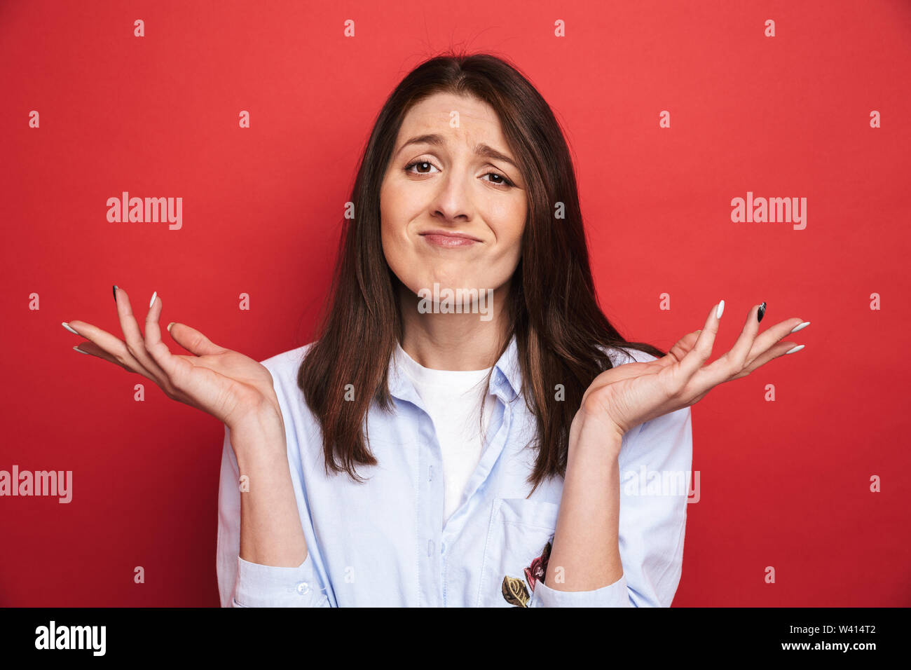 Photo of an amazing confused young beautiful woman posing isolated over ...