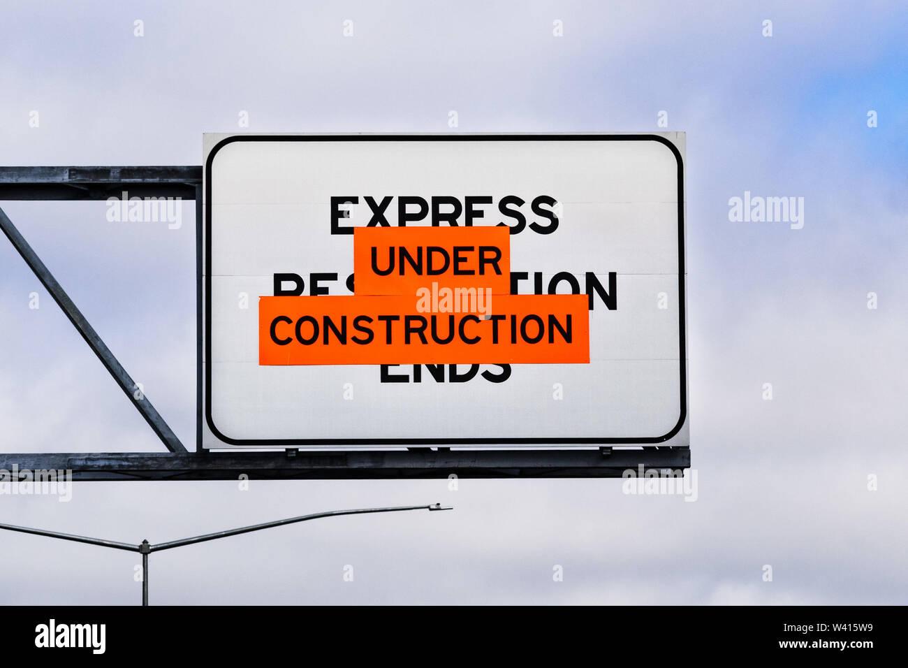 Under Construction "Express Restriction Ends" sign posted on a freeway ...