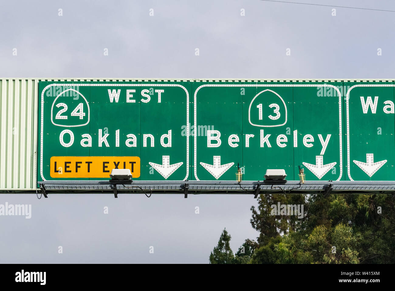Freeway signage providing information about the lanes going to Oakland ...