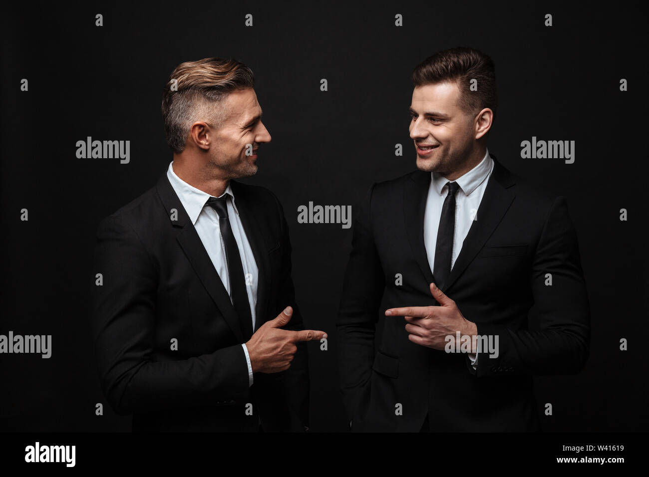 Two Confident Handsome Businessmen Wearing Suit Standing Isolated Over