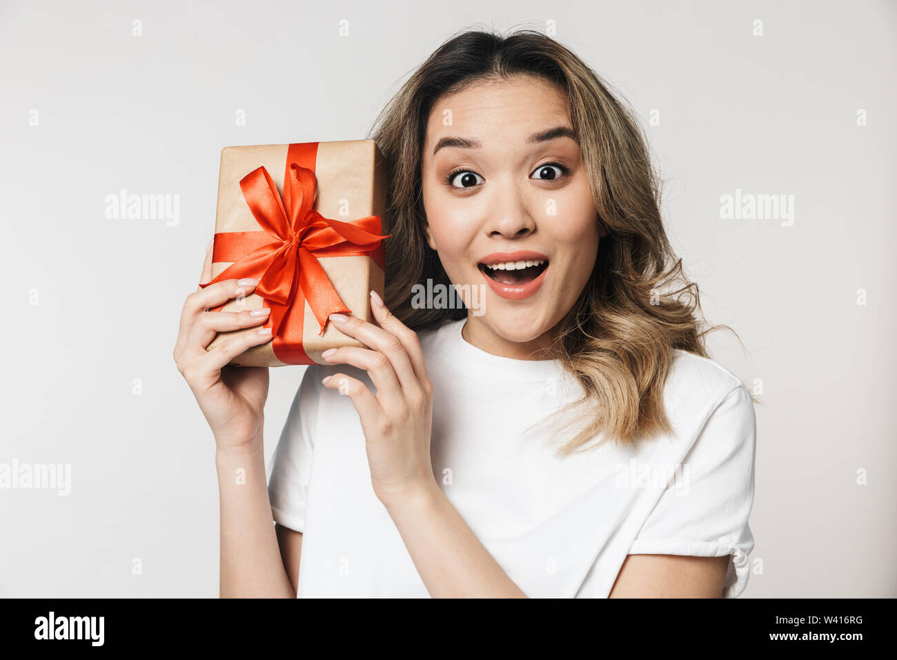 Image of shocked emotional cute young woman posing isolated over white ...