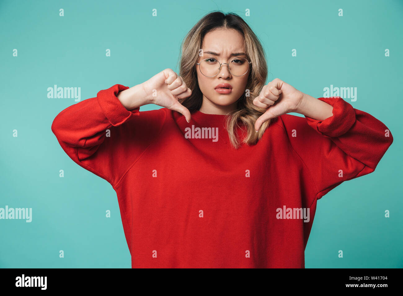 Image of stressed young woman posing isolated over blue wall background ...