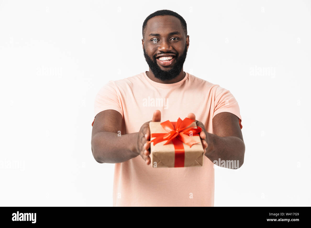 Portrait of a happy excited african man wearing shirt standing isolated ...