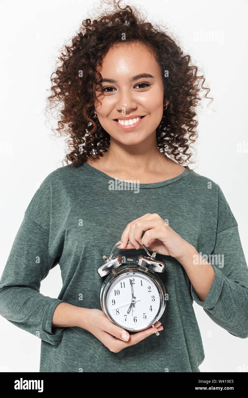 Portrait of a pretty cheerful casual african girl standing isolated ...