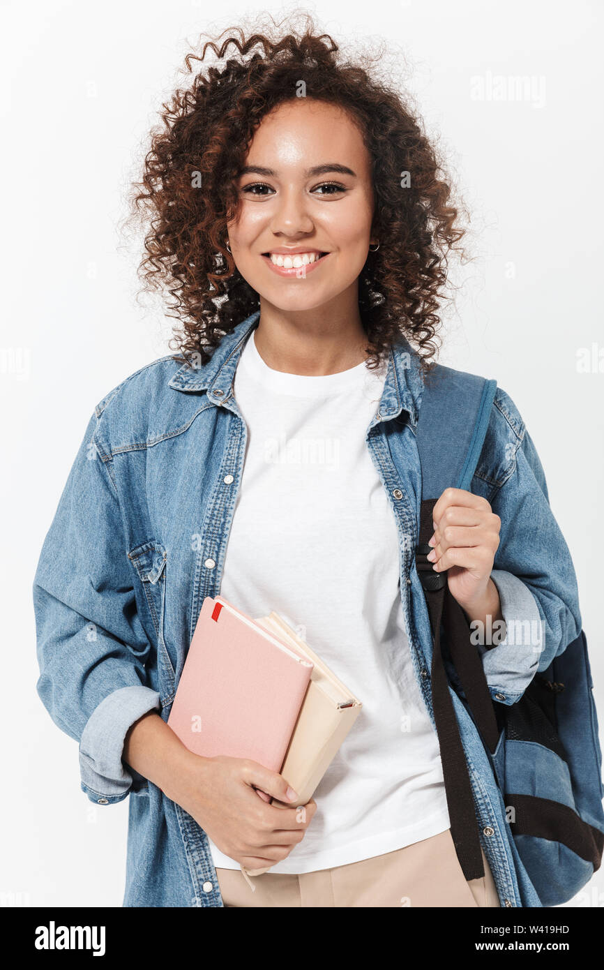 Portrait of a pretty cheerful casual african girl carrying backpack ...
