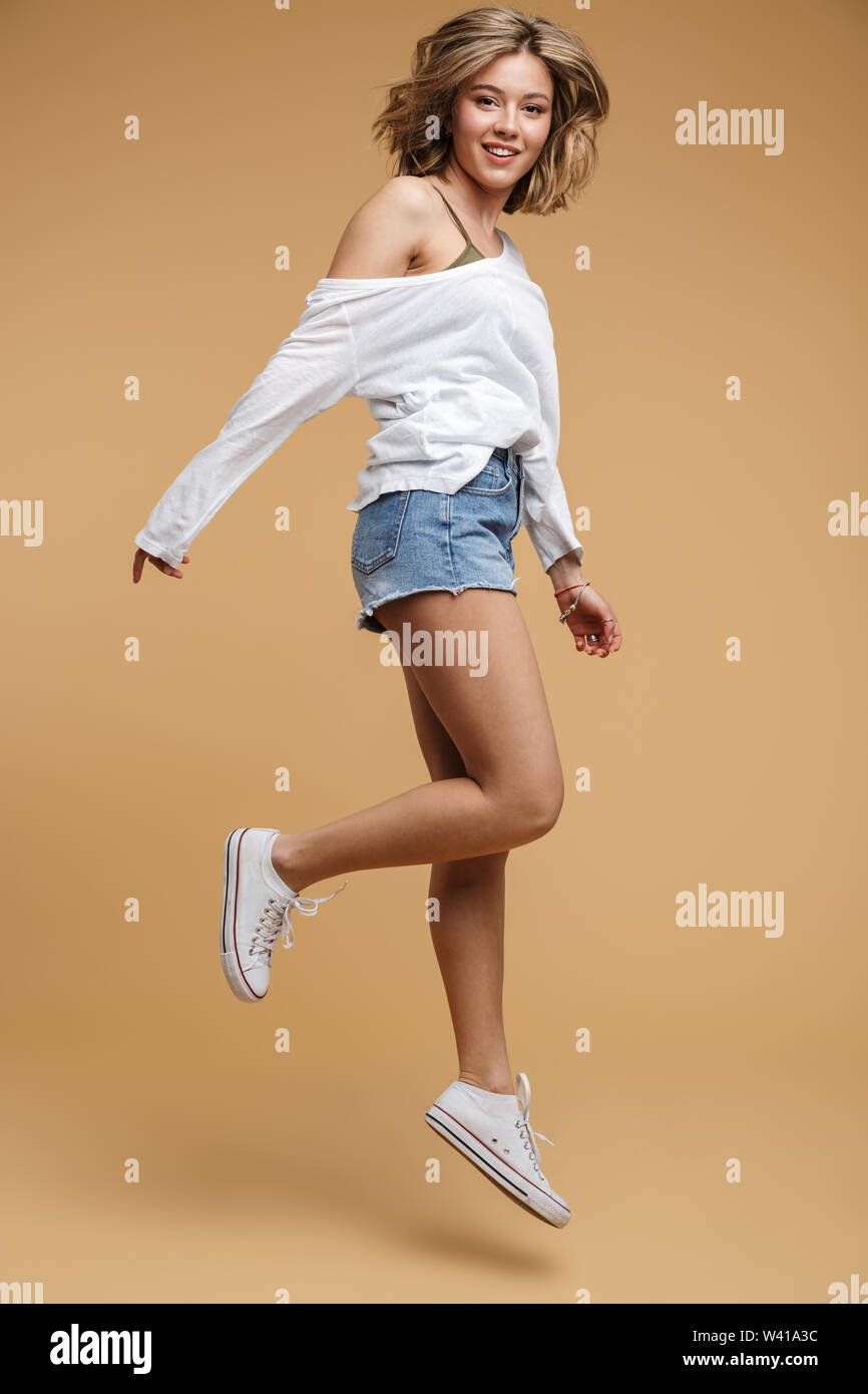 Full length photo of laughing nice woman 20s wearing denim shorts ...