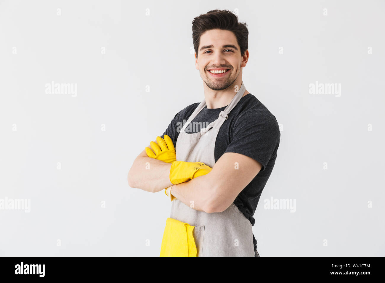Image of a happy young houseman househusband isolated over white wall ...