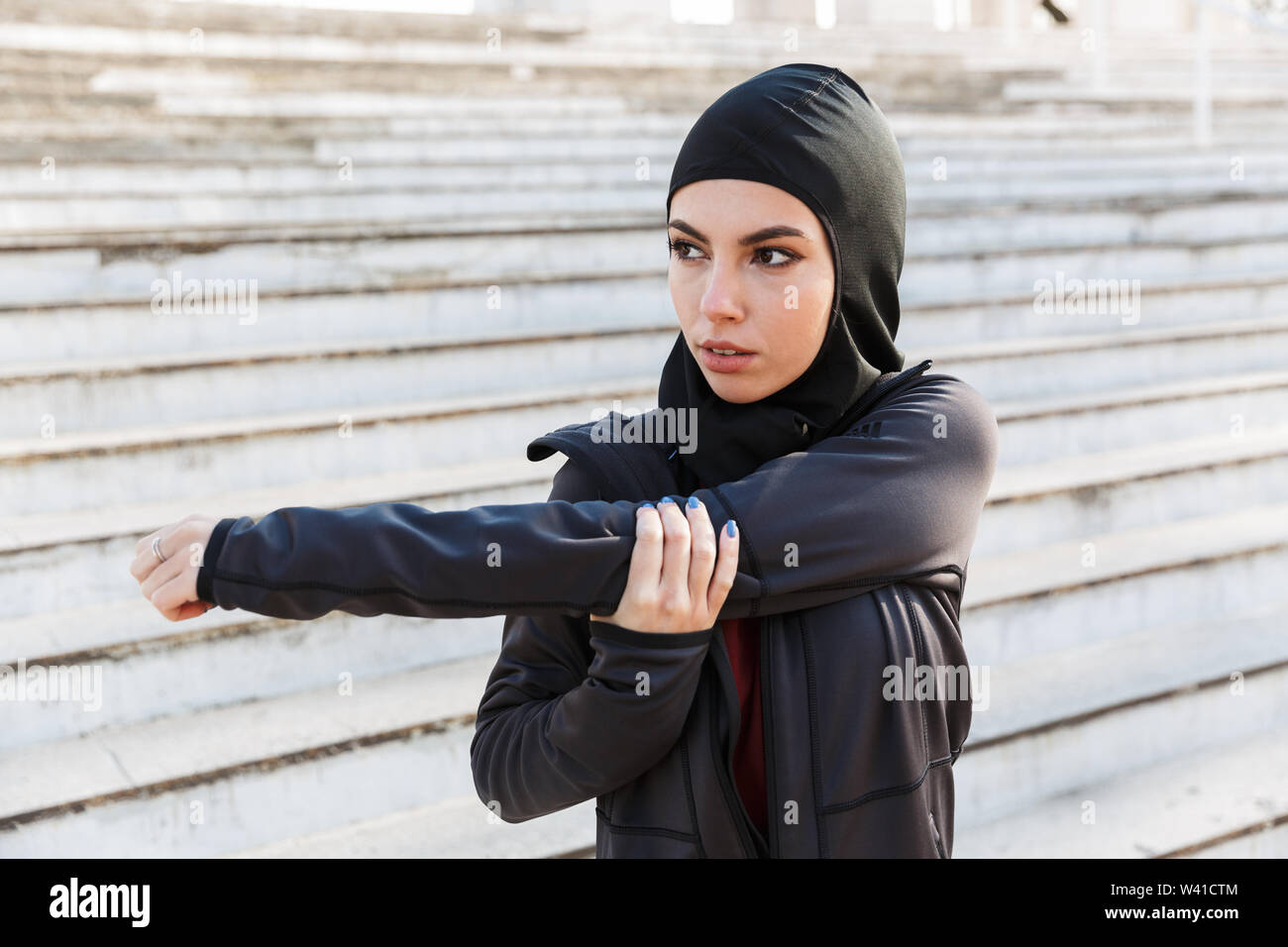 Picture of a young serious muslim sports fitness woman dressed in hijab ...