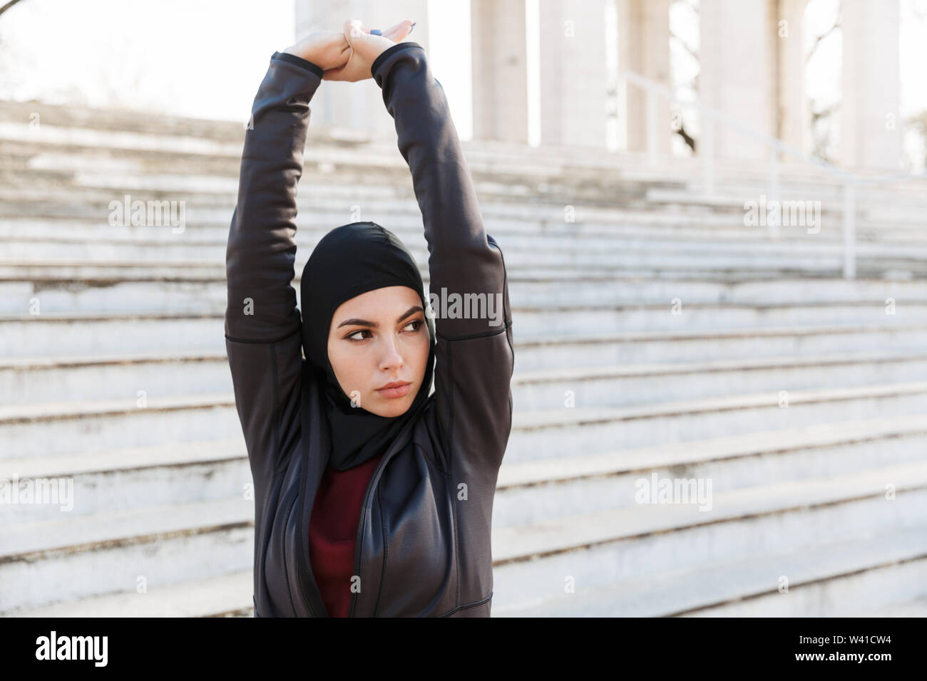 Image of a young concentrated muslim sports fitness woman dressed in ...