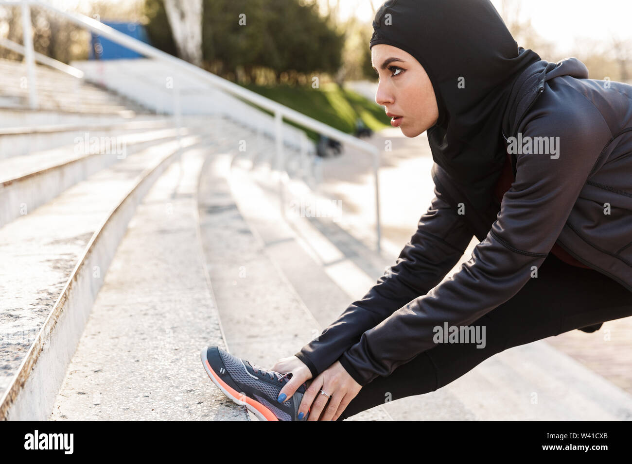 Image of a young concentrated muslim sports fitness woman dressed in ...