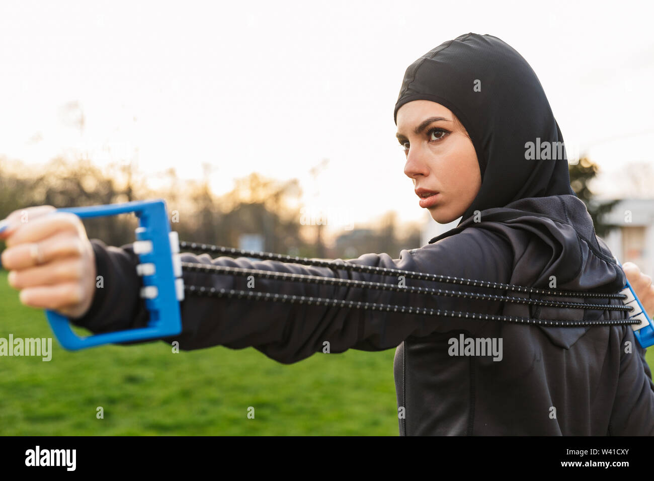 Image of a young concentrated muslim sports fitness woman dressed in ...