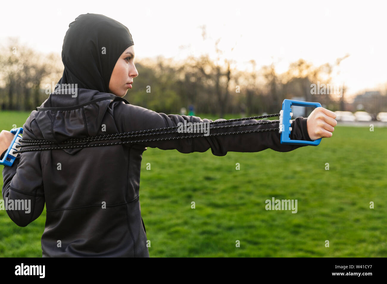 Image of a young concentrated muslim sports fitness woman dressed in ...