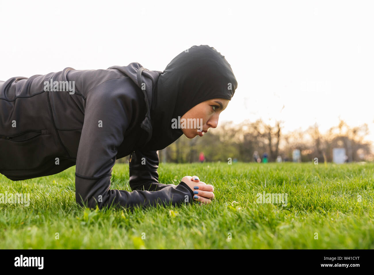 Image of a young amazing serious muslim sports fitness woman dressed in ...