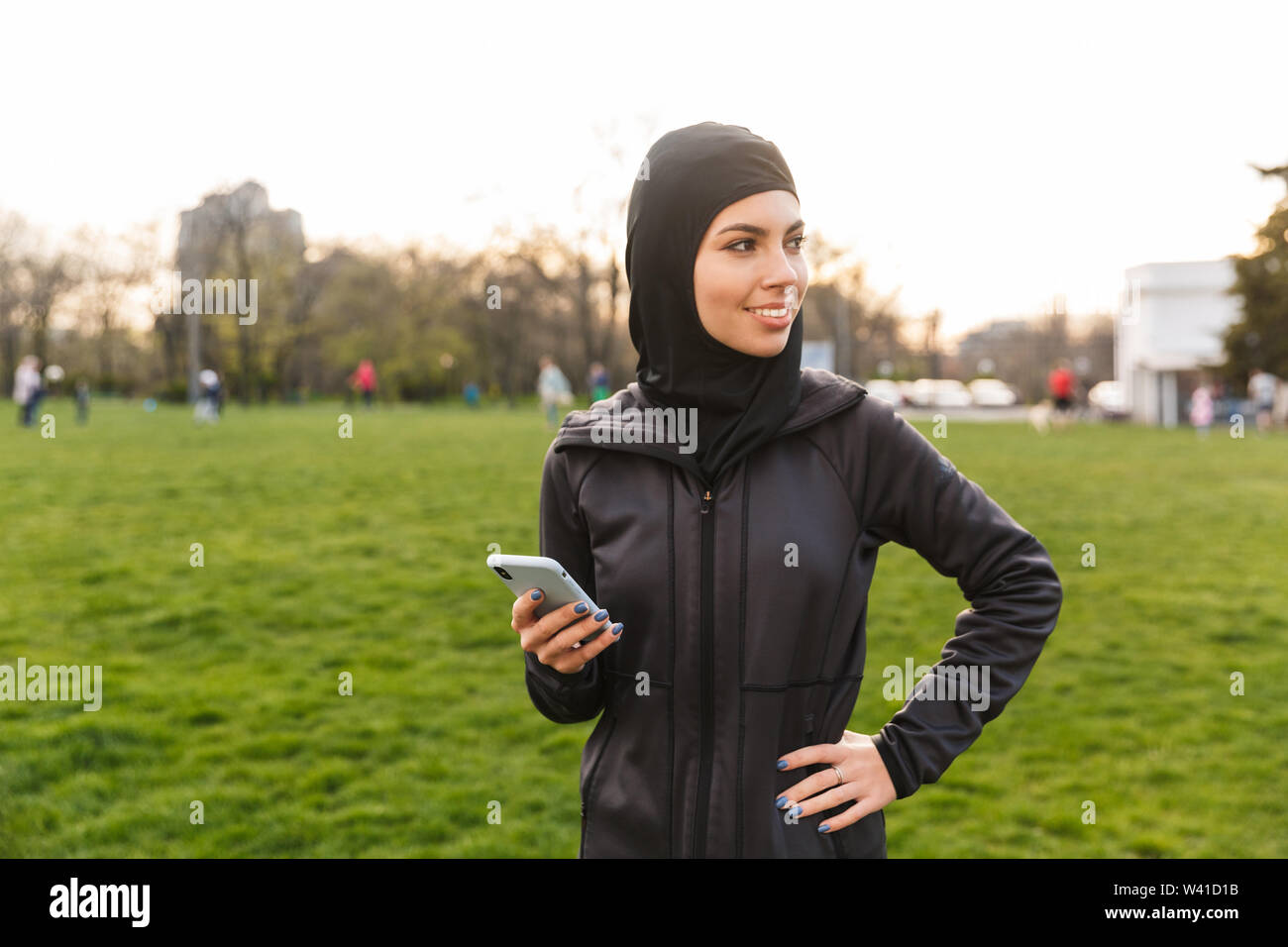 Image of a young happy muslim sports fitness woman dressed in hijab and ...