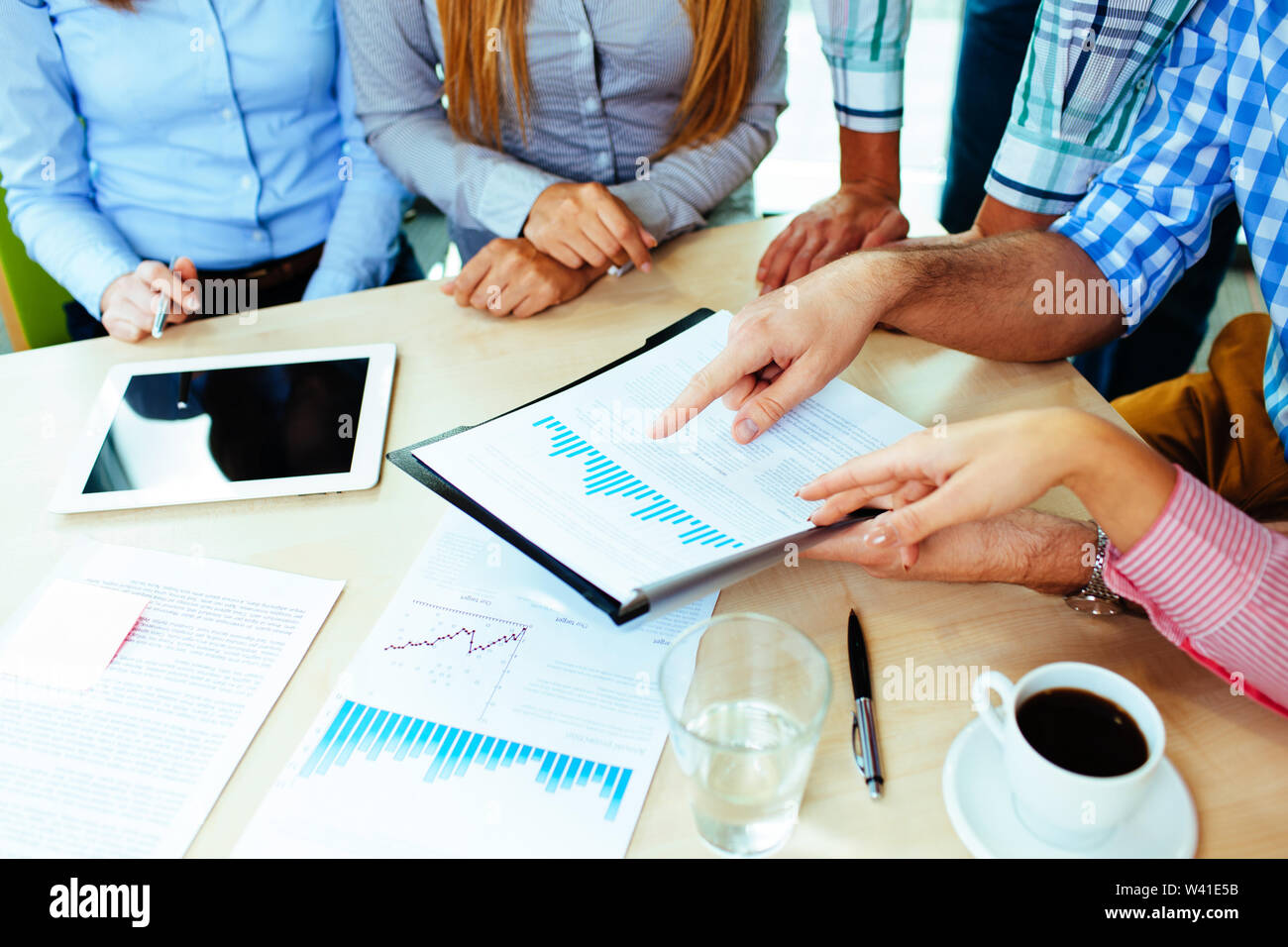 Working at office desk studying charts hi-res stock photography and ...