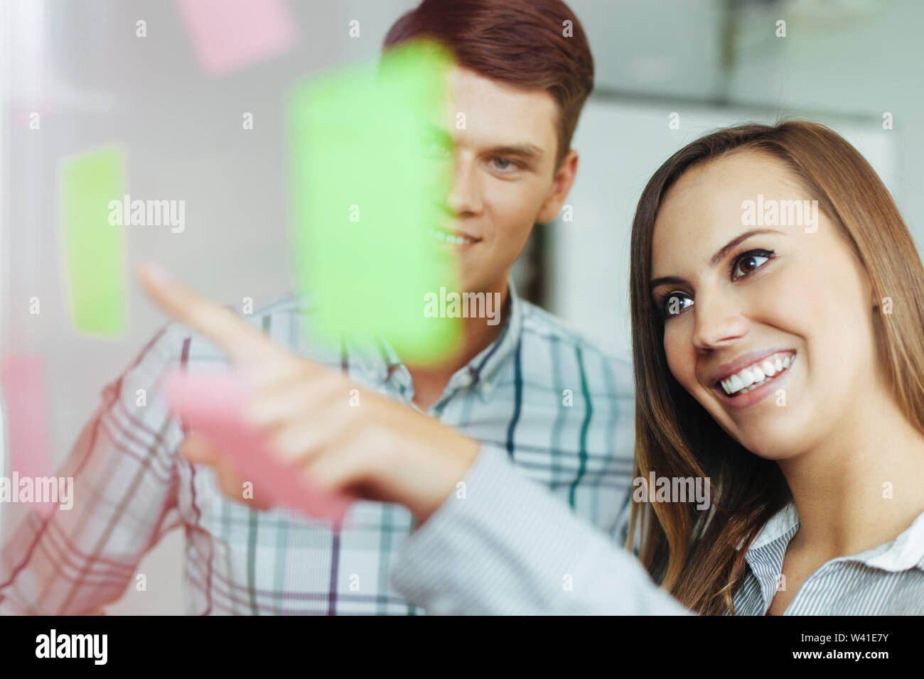 Two happy employees working together in the office Stock Photo - Alamy