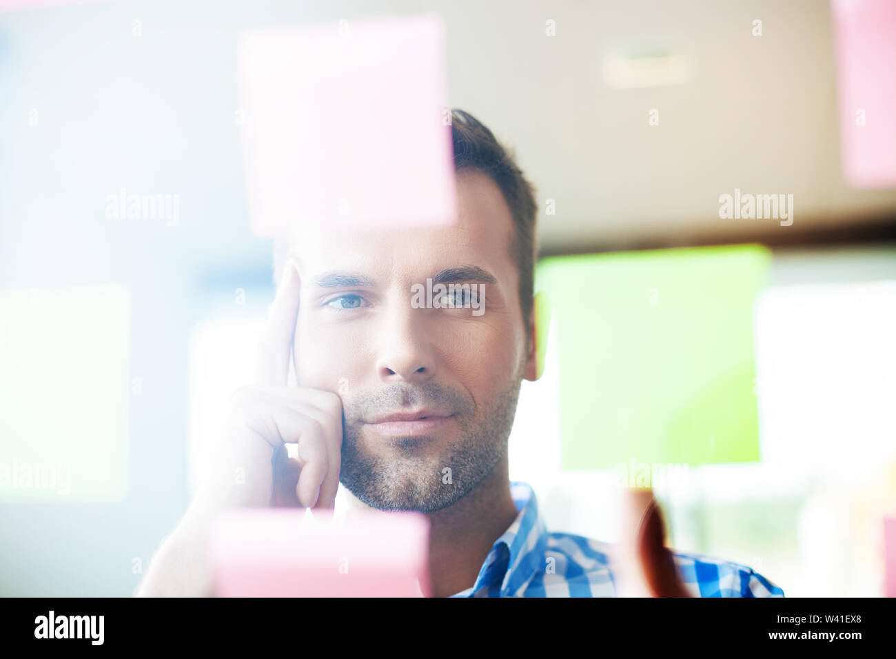 Portrait young creative man pointing hi-res stock photography and ...