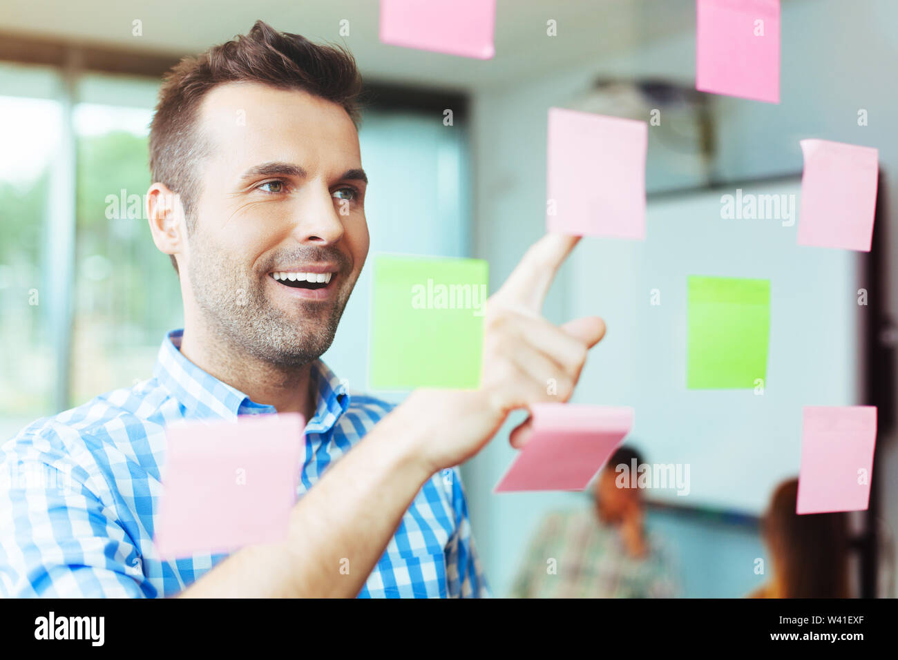 Happy creative employee working in the office Stock Photo - Alamy