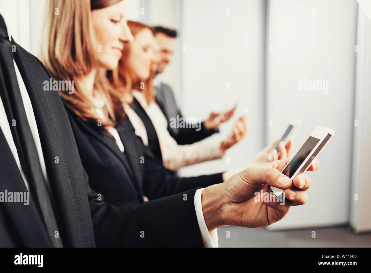 Business people using smartphones Stock Photo - Alamy